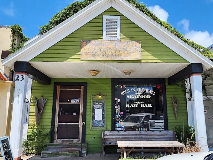 The quaint green building with its weathered wooden bench offers unpretentious charm. Sometimes the most memorable meals come from the most unassuming places.