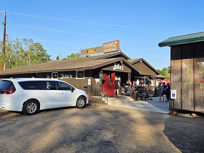 Jake's entrance promises lake views and sizzling plates inside. Those red umbrellas have sheltered countless happy conversations.