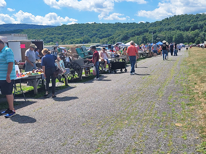Leighty's outdoor market draws crowds who browse under the open sky. Vendors line the gravel paths with everything from practical tools to nostalgic collectibles.