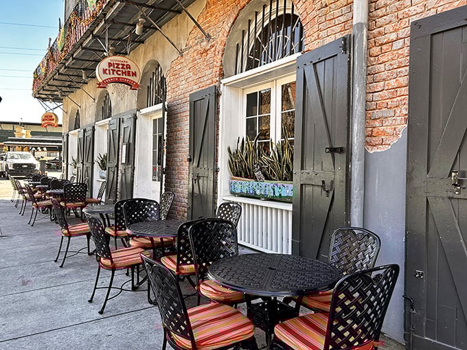 Outdoor seating at Louisiana Pizza Kitchen offers the perfect pizza-with-a-view experience. Brick walls, iron details, and pizza that makes memories.