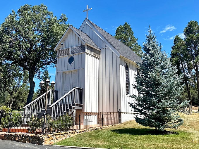 This quaint white chapel in Oakhurst stands like a peaceful sentinel among the pines, offering spiritual respite in nature's embrace.