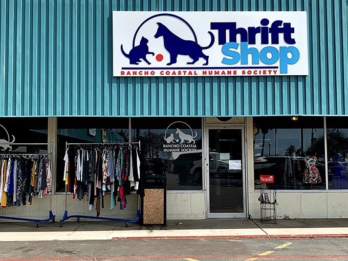 Racks of clothing spill onto the sidewalk outside this animal-loving thrift shop. Every purchase helps a tail wag or a purr rumble.