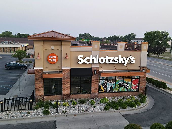 Evening lights make Schlotzsky's glow with sandwich promise. Their distinctive building is as unique as their famous sourdough buns.