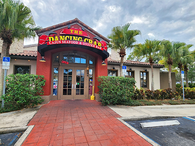 Bold red entrance, palm trees, and promises of Cajun seafood delights. The Dancing Crab's exterior is as vibrant as its flavors.