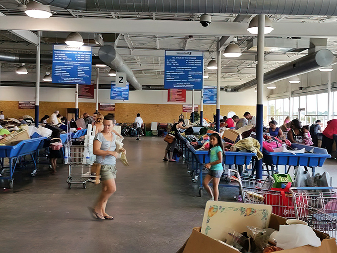 Inside the Goodwill Outlet, blue bins become battlegrounds where patience transforms into incredible finds at pennies per pound.