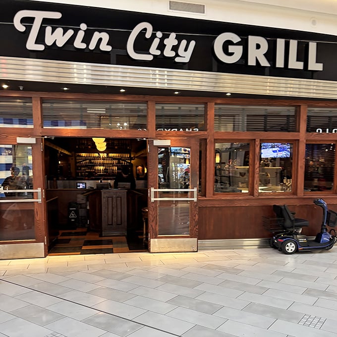 Mall food court? Think again. Twin City Grill's sophisticated entrance promises a proper dining experience amid the shopping madness.