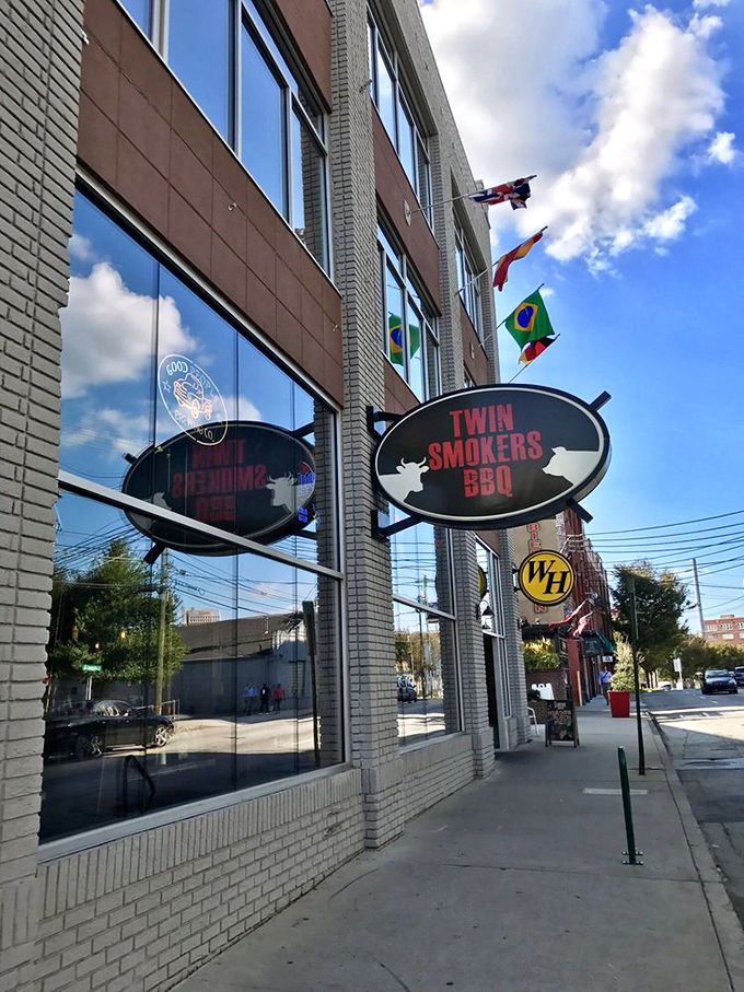 International flags flutter above Twin Smokers' modern facade &ndash; a United Nations of BBQ where beef and pork receive equal diplomatic treatment.
