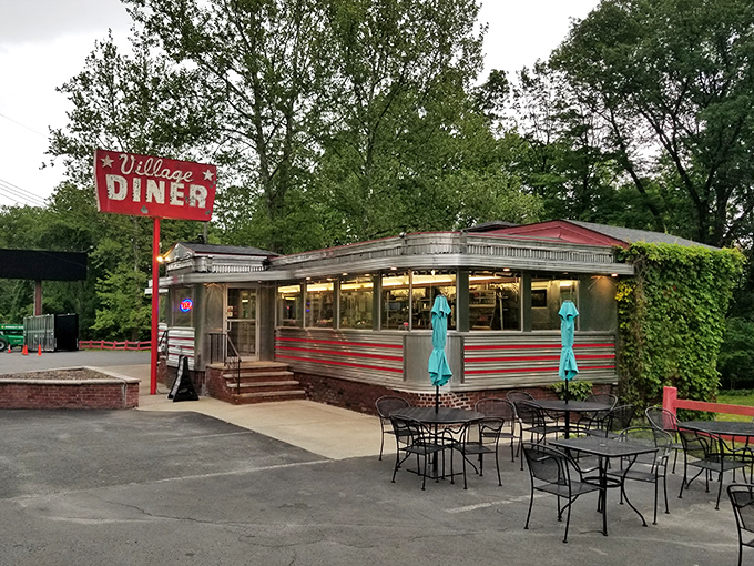 Silver siding gleams in the evening light &ndash; a classic American diner where every booth tells a story.