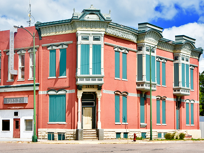 This 19th-century building wears its history proudly, with those magnificent turquoise windows serving as the architectural equivalent of statement jewelry. 