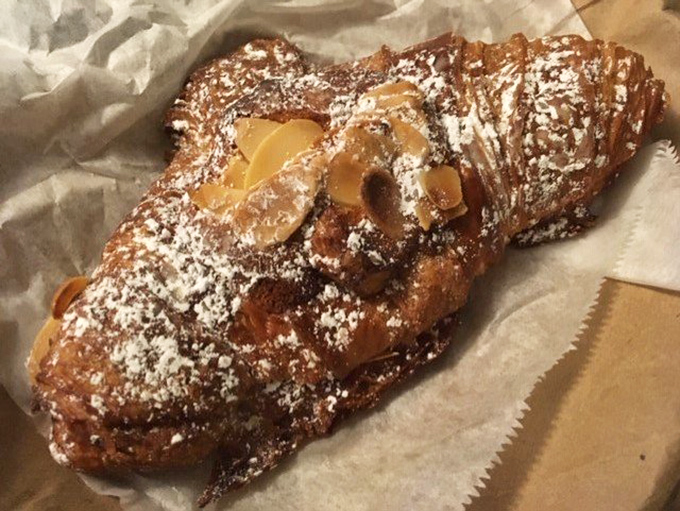 The almond croissant—a buttery, flaky marvel dusted with powdered sugar—might just be worth planning your entire Florida vacation around.