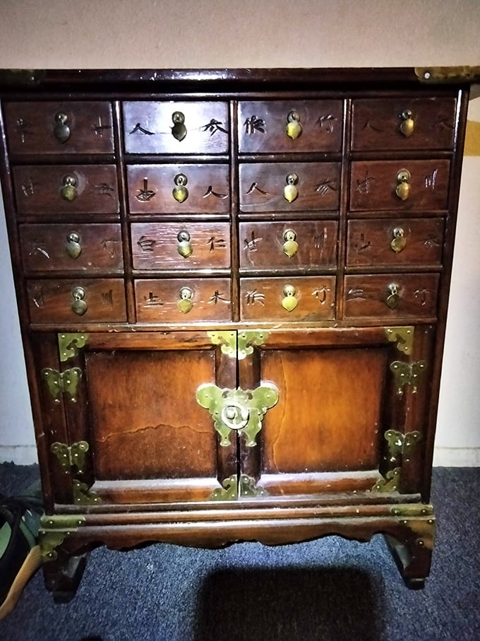 This ornate Asian apothecary cabinet whispers stories from another era. Imagine the conversations this piece could start in your entryway!