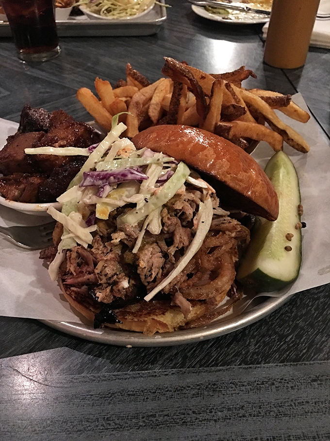 Sandwich architecture at its finest. This pulled pork masterpiece, topped with fresh slaw and paired with hand-cut fries, is Burlington's answer to lunch perfection.