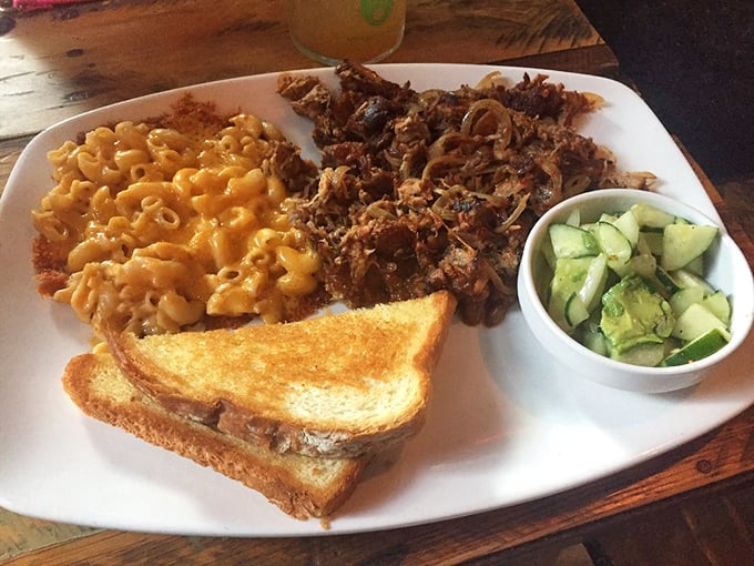 Mac and cheese that glows like liquid gold alongside pulled pork that's been slow-cooked to tender perfection. Comfort food that hugs your soul.