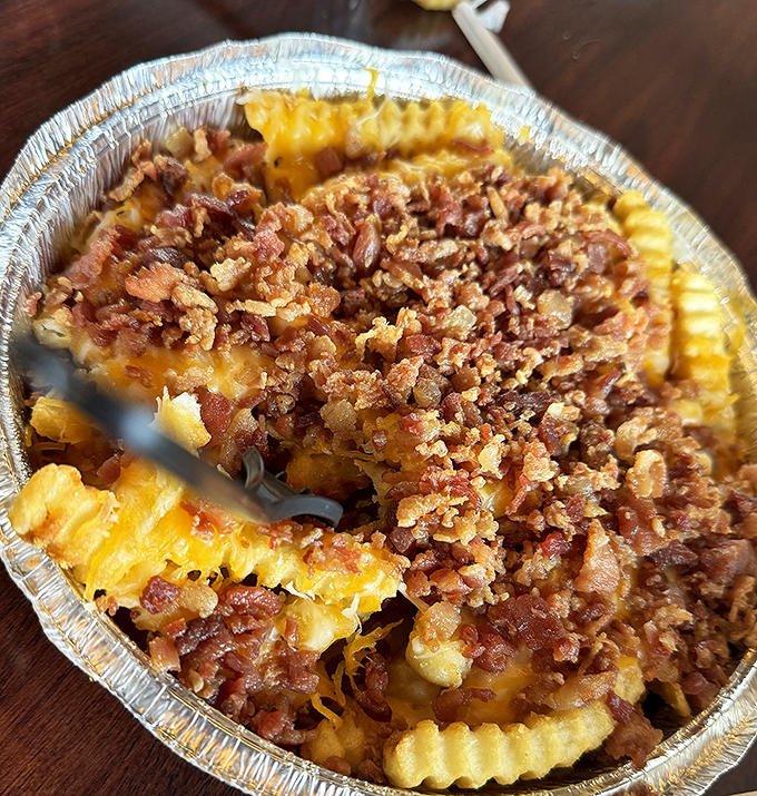 Bacon cheese fries that don't apologize for being exactly what they are: a glorious, melty monument to comfort food that laughs in the face of diet culture.