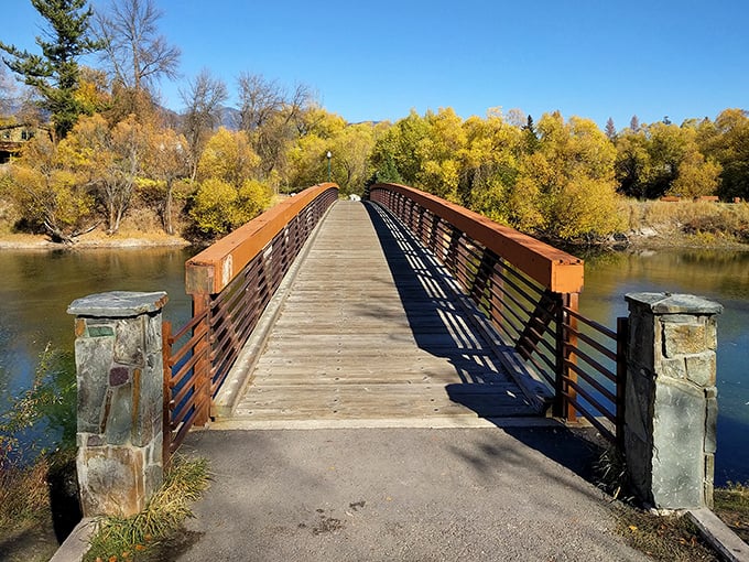 This peaceful bridge crossing captures Whitefish's autumn splendor, where golden trees frame a scene straight out of a Robert Frost poem.
