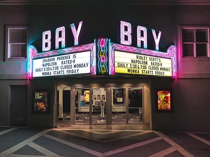 The Bay Theater's neon sign glows with small-town charm, offering entertainment without the big-city prices or parking nightmares.
