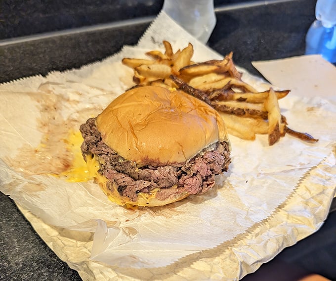Behold the beef sandwich in its natural habitat &ndash; charred edges, tender center, and a kaiser roll struggling nobly with its delicious burden.