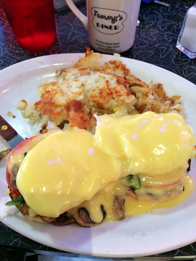 That hollandaise sauce is doing the Lord's work, blanketing perfectly poached eggs like a delicious yellow security blanket.