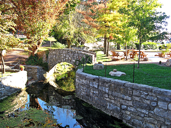 Big Spring Park's stone bridge reflects in crystal waters like something straight out of a Thomas Kinkade painting &ndash; minus the excessive cottages.