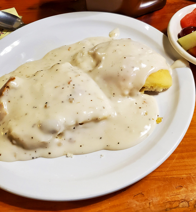 Biscuits buried under creamy gravy&mdash;the kind of comfort food that makes you forget about counting calories forever.