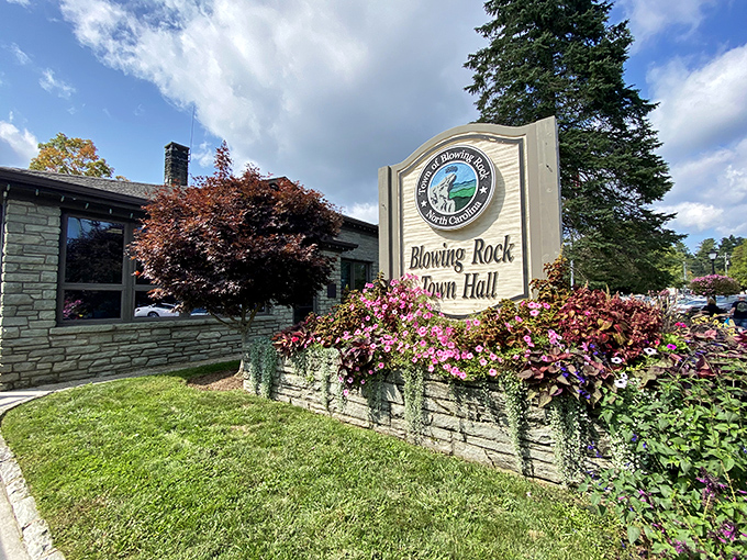 The Town Hall sign surrounded by cascading flowers&mdash;civic pride with a side of botanical showing off.