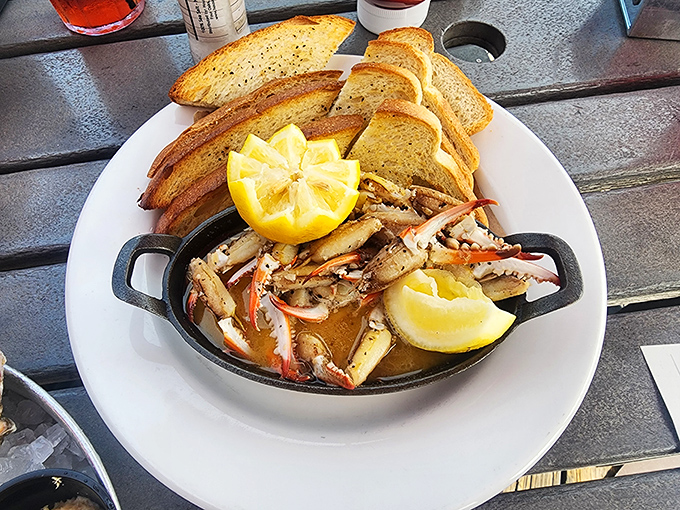 Blue crab claws bathing in butter with sourdough toast standing by &ndash; nature's perfect dipping vessels for liquid gold.