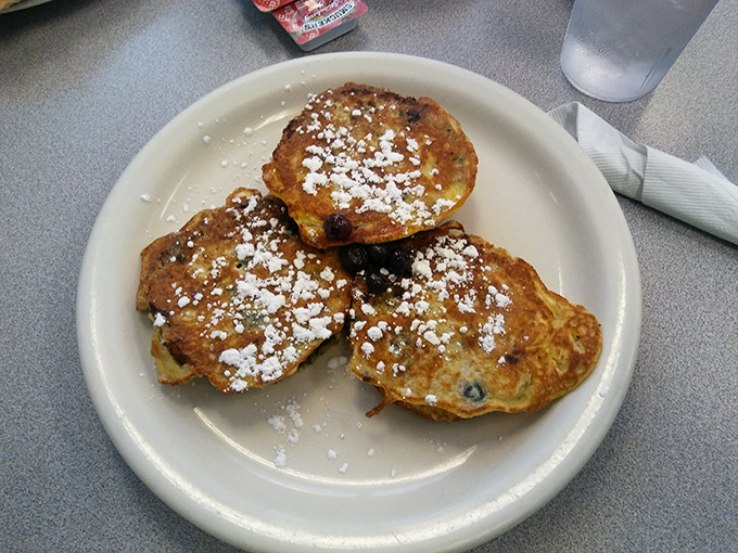 These blueberry pancakes aren't just breakfast&mdash;they're little golden discs of joy dusted with powdered sugar snowfall.