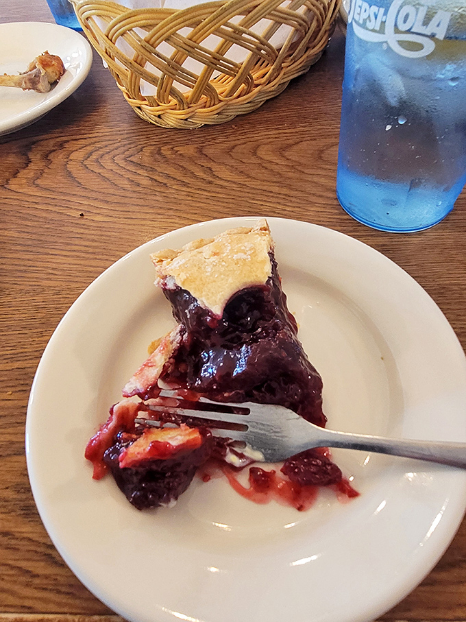 Fork meets berry pie in a moment of sweet surrender. The juice running wild tells you this isn't some factory-made imposter.