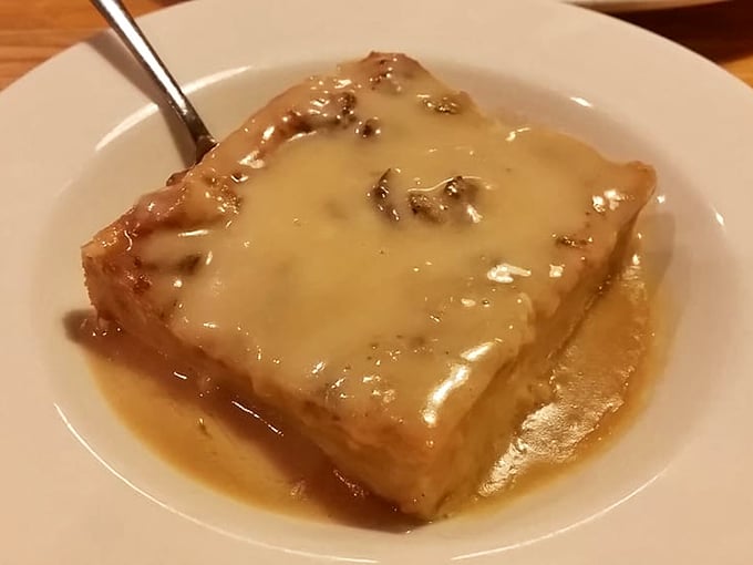 Bread pudding swimming in buttery sauce proves that Louisiana doesn't just do savory—they absolutely crush dessert too, friend.