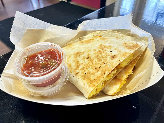 This breakfast quesadilla doesn't just break fast—it shatters expectations with golden-brown perfection and a side of salsa that means business.
