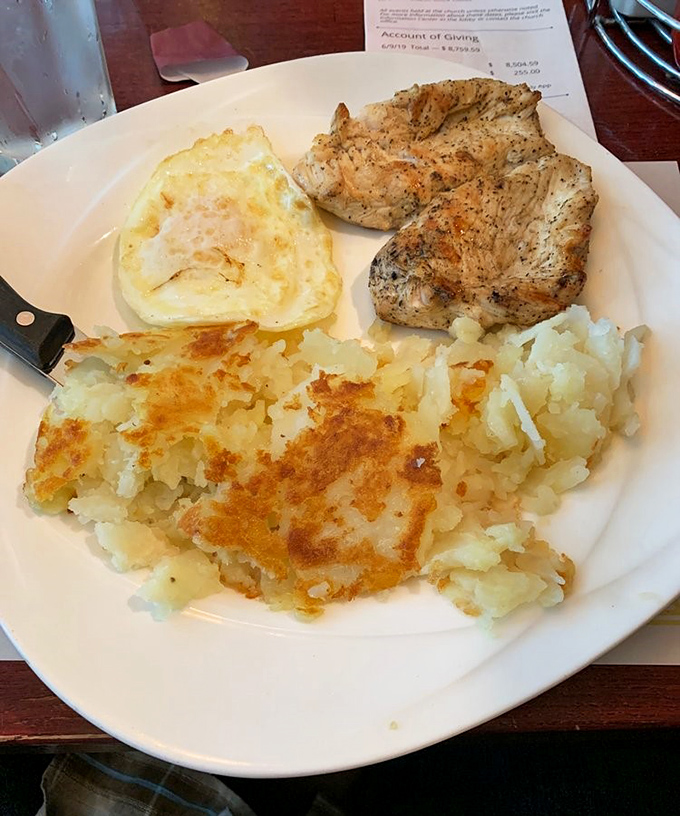 The holy trinity of breakfast: perfectly cooked eggs, golden hash browns, and chicken that didn't hit the snooze button.