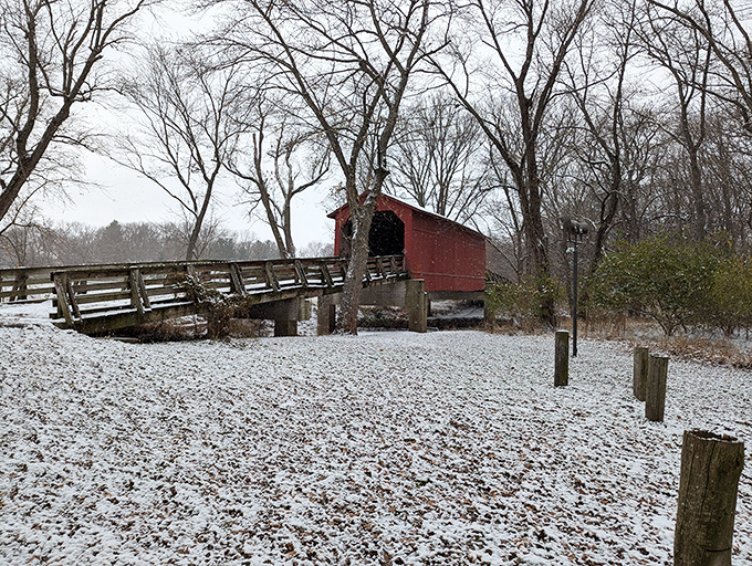 Even in winter's embrace, the crimson bridge stands out like a cardinal against the snow, defying the monochrome landscape.