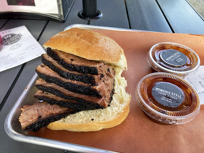 Brisket sliced thicker than a Chicago winter coat, with a smoke ring so perfect it could be framed in an art gallery.