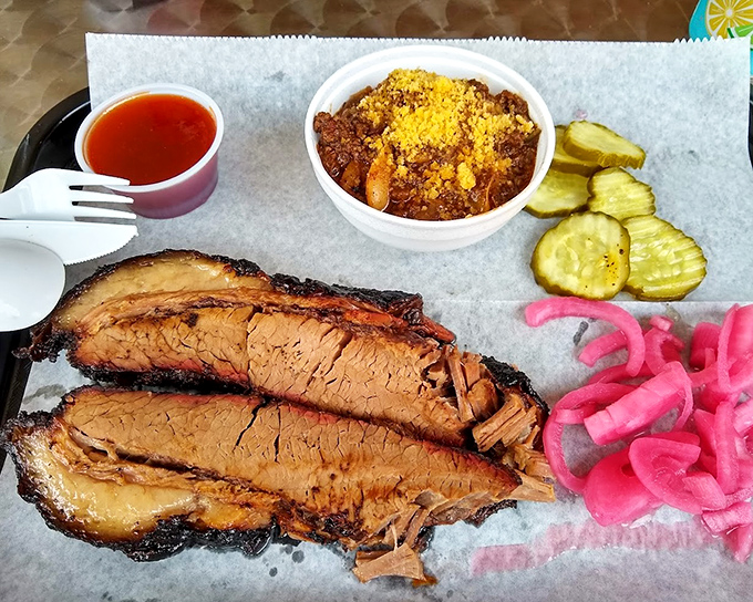 Brisket slices with bark so beautiful they belong in a museum. The pink smoke ring is nature's way of saying "patience pays off."