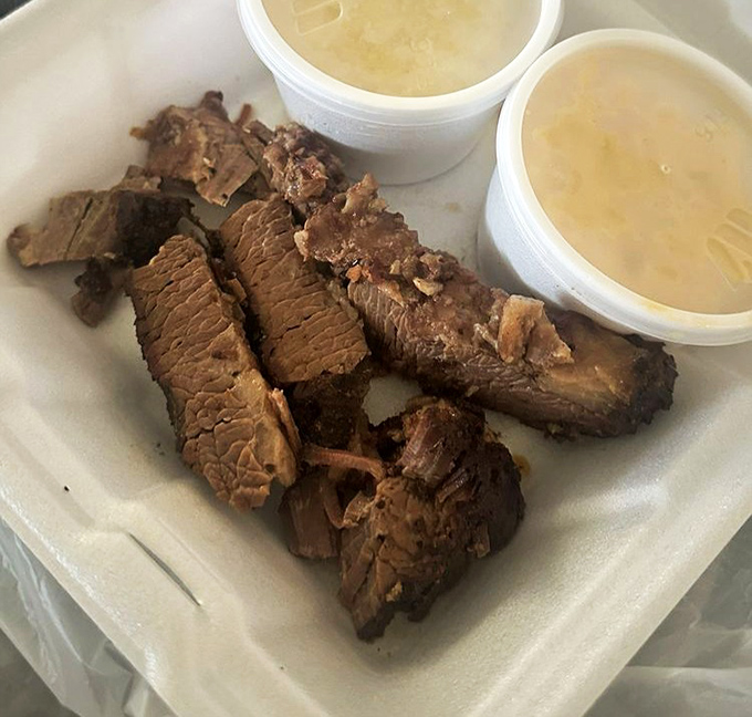 Brisket that's been introduced to smoke and time, resulting in a beautiful relationship. Those sauce cups are just waiting for their moment.