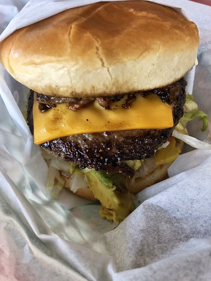 Behold the star of the show &ndash; a burger with edges crisped to perfection on that legendary flat-top grill. No filter needed for this beauty.