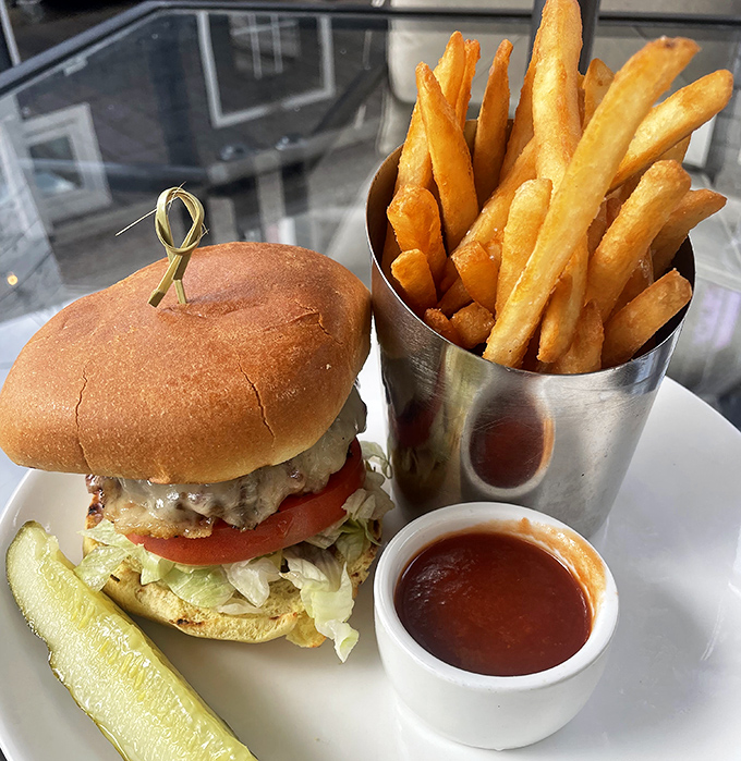 A burger that demands to be photographed before eaten, paired with golden duck fat fries standing at attention in their metal cup. Fast food's sophisticated cousin has arrived.