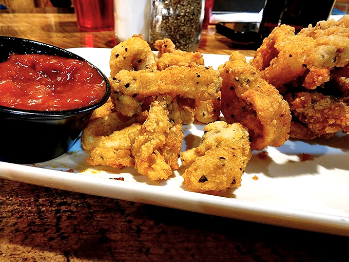 Golden-fried calamari that actually tastes like something from the ocean, not rubber bands in disguise. The dipping sauce seals the deal.