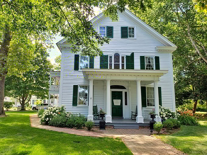 This stately white home with perfect symmetry and rocking chairs looks like it's waiting for someone to bring out a pitcher of sweet tea.