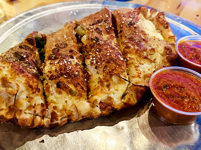 This isn't just a calzone; it's a fortress of flavor with walls of perfectly baked dough protecting a treasure of melted cheese and fillings.