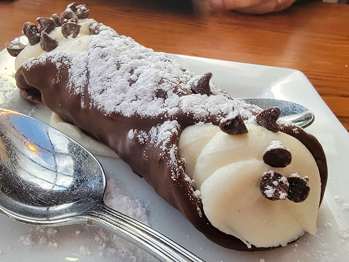 This cannoli isn't just dessert; it's architecture, sculpture, and poetry all wrapped in a crispy shell dusted with powdered sugar.