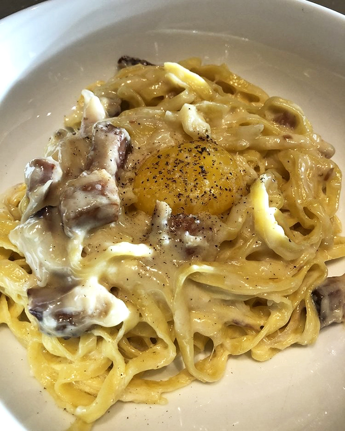 This carbonara with its perfectly runny egg center isn't just pasta—it's what Italian dreams are made of, minus the Vespa and the dramatic hand gestures.