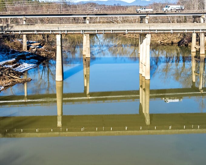 The Catawba River flows beneath this sturdy bridge, reflecting winter skies and offering a peaceful respite from urban life.