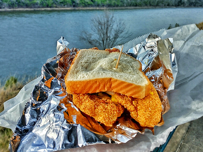 The famous catfish sandwich in its natural habitat&mdash;aluminum foil, with a waterfront view that makes everything taste even better.