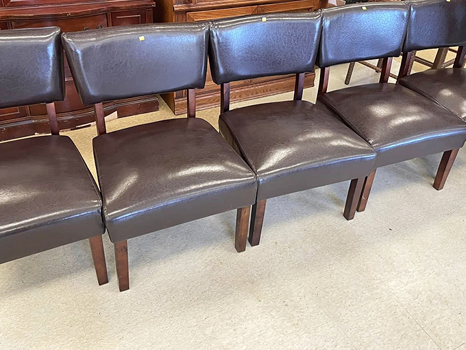 These dignified dining chairs stand at attention like well-dressed waiters, ready to serve your family gatherings with their leather-clad charm.