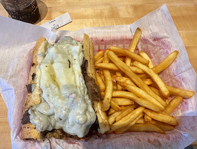 Melted cheese cascading over thinly sliced steak like a dairy waterfall. This sandwich doesn't just satisfy hunger&mdash;it creates happiness with every bite.