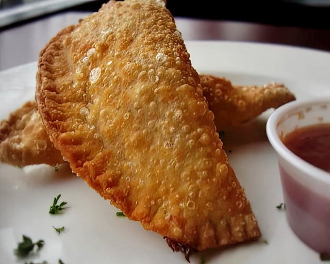 Golden-fried cheese empanadas that shatter with each bite, revealing a molten interior that makes you wonder why you'd ever eat mozzarella sticks again.