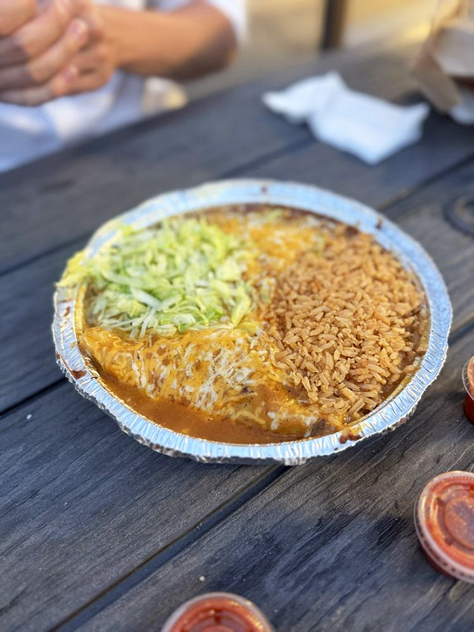 Cheese enchiladas swimming in red sauce that's been simmering since before your morning alarm. The rice isn't a side&mdash;it's an essential supporting actor.