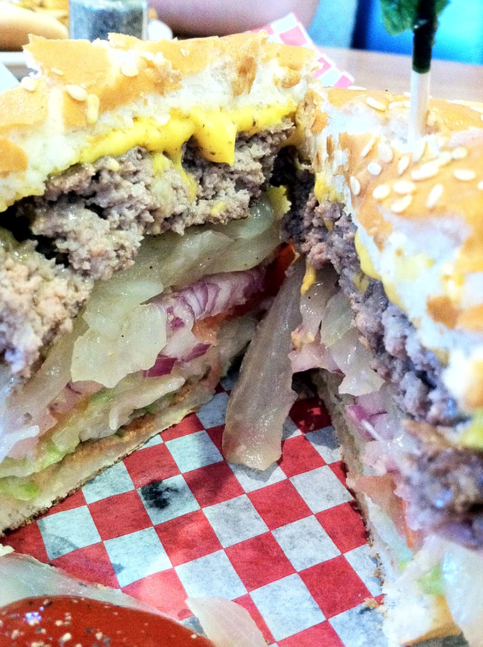 The cross-section of a perfect burger reveals the architecture of flavor&mdash;layers of beef, cheese, and caramelized onions in harmonious balance.