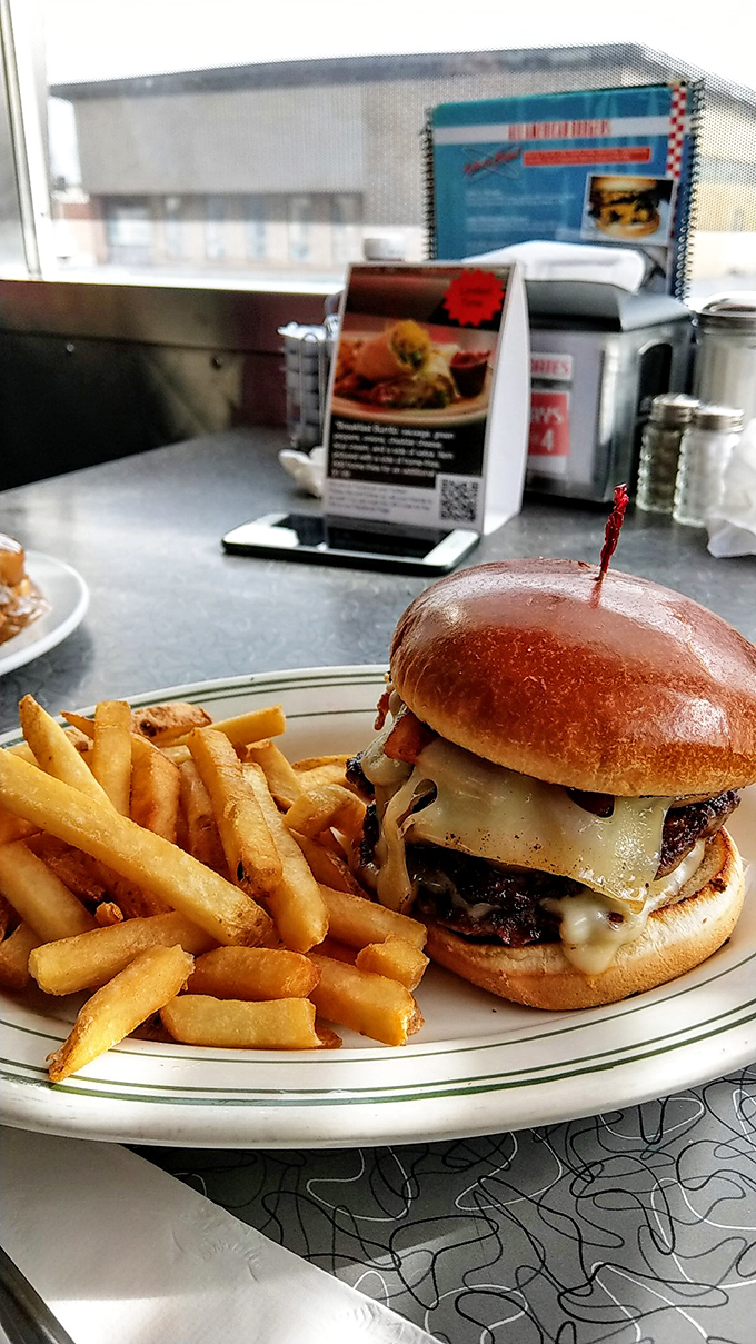 A proper diner burger doesn't need fancy aioli or artisanal buns&mdash;just honest beef, melty cheese, and fries that crackle with each bite.